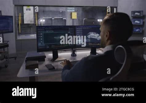 An Engineer In A Crash Test Lab Uses A Car Crash Test System To Simulate A Traffic Accident To