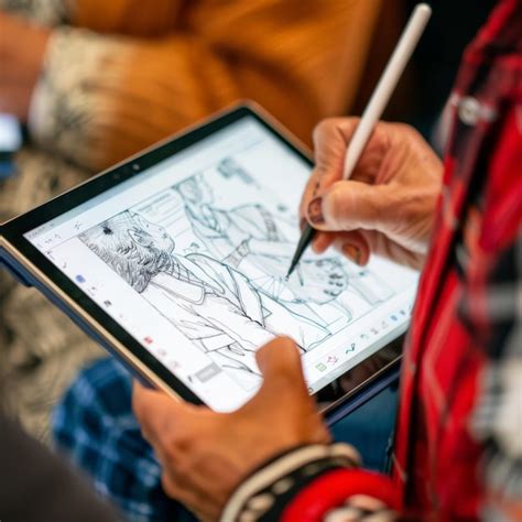 Premium Photo An Artist Creating Digital Illustrations On A Tablet Using A Stylus Pen The