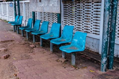 Premium Photo Empty Chairs On Sidewalk Against Buildings In City