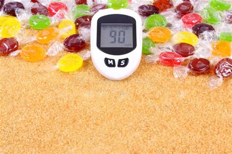 Glucose Meter For Measuring Sugar Level Candies And Granulated Brown Cane Sugar Stock Image