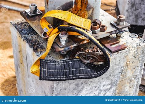 The Safety Belt Of A Welder Or Assembler Lies On A Concrete Foundation At A Construction Site