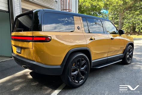 compas yellow rivian r1s with triple square running boards ev