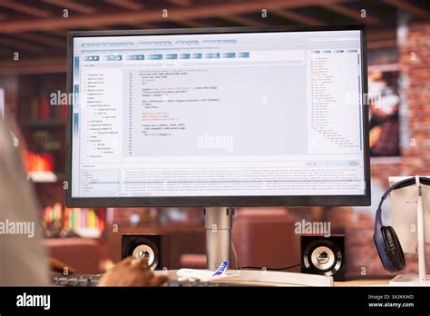 Coder At Workstation Programming On Computer Writing Lines Of Code