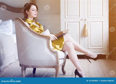 Young Redhead Woman Sitting In Chair Reading Book Stock Image Image