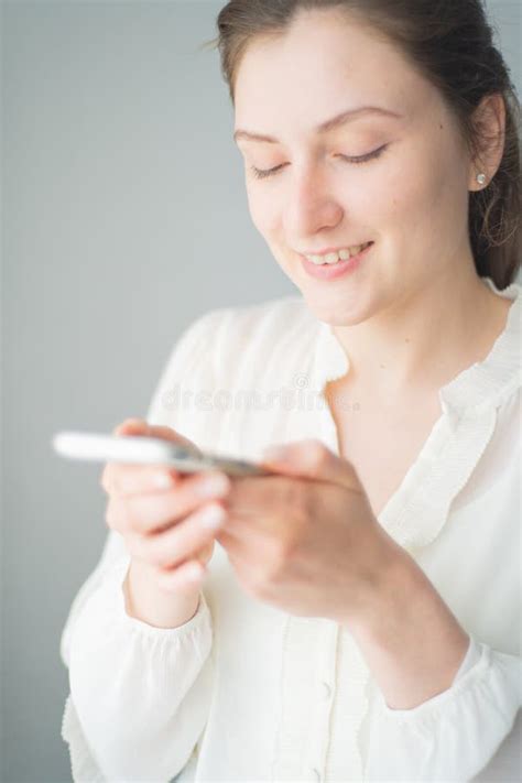 A Young Woman Using Voice Recording Of Voice Recognition Phone On
