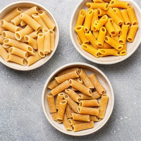 Premium Photo Top View Of Three Types Of Small Raw Macaroni In Plates
