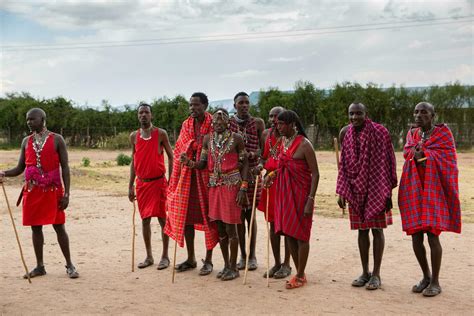 Masai In Traditional Colorful Clothing Showing Maasai Jumping Dance At