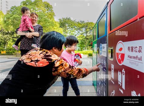 A Chinese Elderly Woman Teaches Her Grandbabe To Learn Garbage Sorting In Hai An City