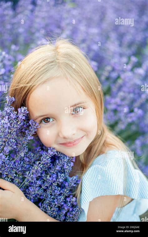 Portrait Of Cute Little 5 Year Old Girl With Brown Eyes In Blue Dress