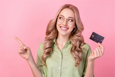 Portrait Of Charming Lady Hold Debit Card Look Indicate Finger Empty Space Isolated On Pink