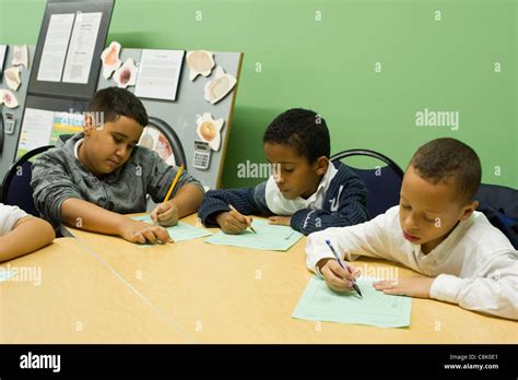 Second And Third Graders Do An Assignment During An After School