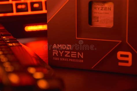 A Close Up Of An Amd Ryzen 9 3900x Processor In A Packaging Box With Backlit Keyboards In The