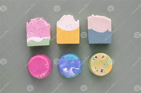 Pieces Of Different Shapes And Colors Of Handmade Soap On A Green