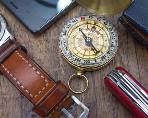 Premium Photo High Angle View Of Navigational Compass And Currency On Table