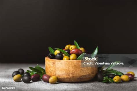 배경에 녹색 빨간색 검은색 올리브 세트 그릇에 담긴 다양한 종류의 올리브와 신선한 올리브 잎을 곁들인 올리브 오일 진미지중해식 주방 복사 공간 갈색에 대한 스톡 사진 및