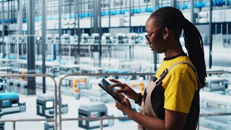 engineer in smart factory implementing automated workflows stock