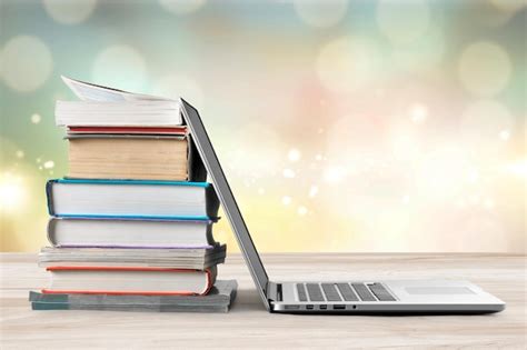 premium photo stack of books with laptop