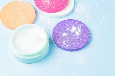 Translucent Powder In Green Jar With Makeup Sponges On Blue Background Close Up Stock Image