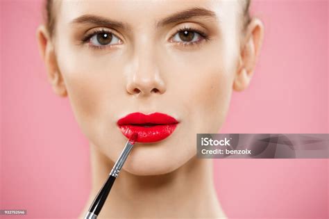 뷰티 개념핑크 스튜디오 배경으로 빨간 립스틱을 적용 하는 여자 아름 다운 여자 화장은 반짝이는에 대한 스톡 사진 및 기타 이미지 반짝이는 백인종 사람 얼굴 Istock