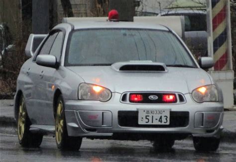Silver Police Car Driving In The Rain