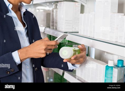 Businesswoman Scanning Product S Barcode Through Smart Phone Stock Photo Alamy
