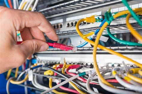 Hand Of Engineer Plugging In Ethernet Cable Into Server Switch P Stock