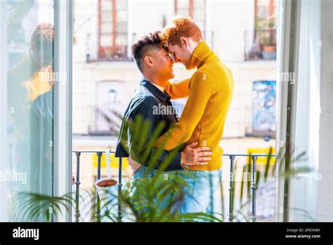 Beautiful Gay Couple Being Romantic By The Window Holding Each Other