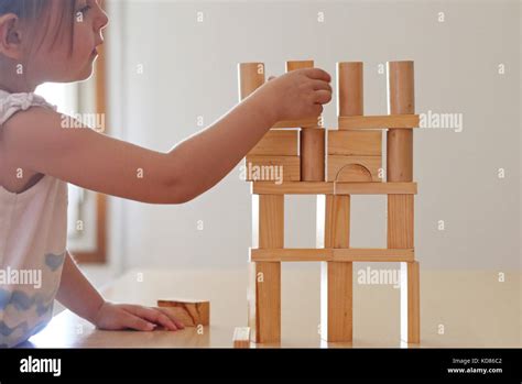 Girl Playing With Wooden Building Blocks Stock Photo Alamy