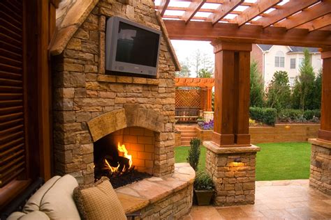 Modern Outdoor Living Area With Stone Fireplace And Pergola Outside