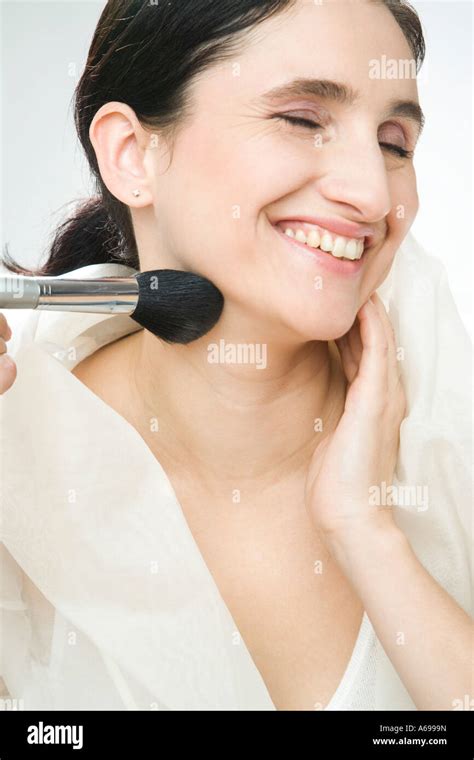 Woman Applying Powder Stock Photo Alamy