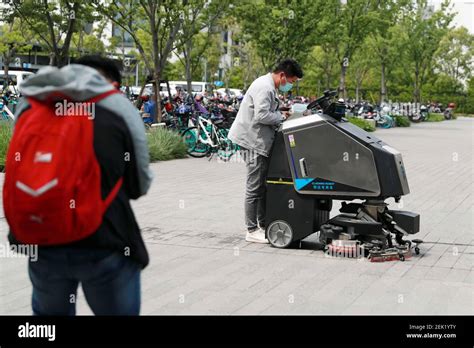 A Person Checks On One Of The Cleaning Robots From Gaussian Robotics At The Headquarter Of