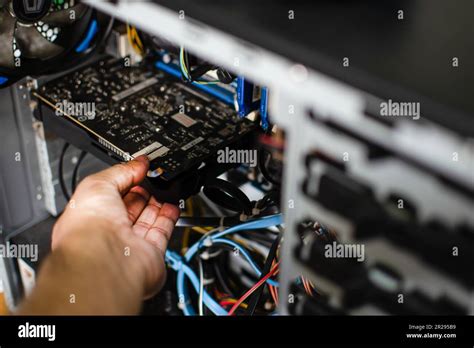 a technician s hand holds the graphics card to fix it the vga card is