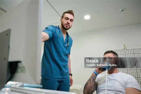 Experienced Pulmonologist Performing Spirometry Test On Adult Person