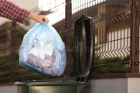 Man Putting Garbage Bag Into Recycling Bin Outdoors Closeup Stock Image Image Of Disposable