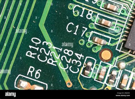 Close Up View Of A Green Computer Board With Visible Traces Solder