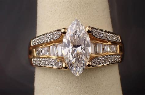 Lot - CUBIC ZIRCONIA AND FOURTEEN KARAT YELLOW GOLD RING