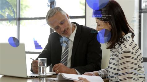 Premium Stock Video Animation Of Globes Graphs And Computer Language Over Caucasian Coworkers