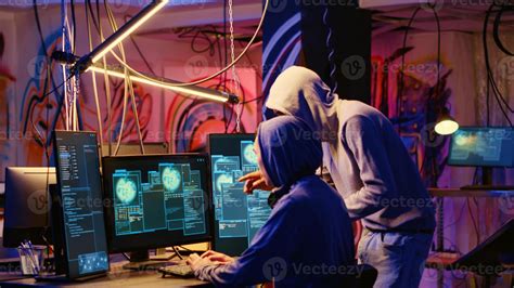 Hackers In Neon Lit Room Writing Lines Of Code On Computer Having Burst Of Joy After
