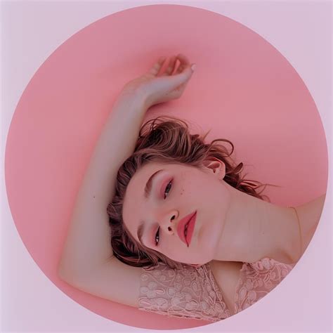 Portrait Of A Beautiful Girl In A Pink Dress On A Pink Background