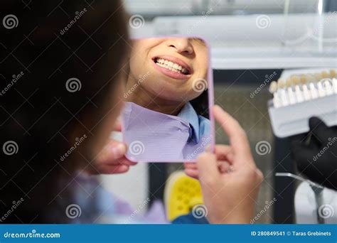 Beautiful Smile Of A Female Patient Looking At Mirror Reflection