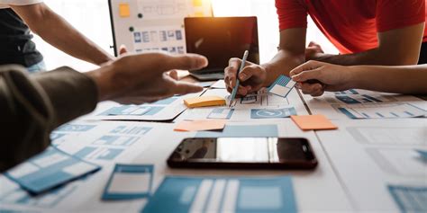 Close Up Ux Developer And Ui Designer Brainstorming About Mobile App