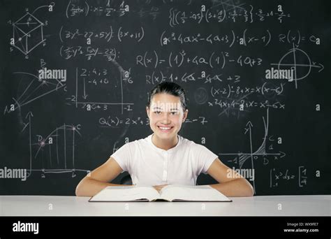 Student Sitting In Front Of A Blackboard Full Of Math Formulas Stock Photo Alamy