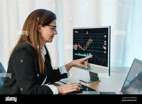 Female Trader Working With Chart On Computer Monitor Stock Photo Alamy