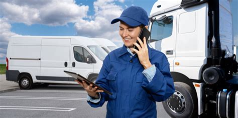 밴과 트랙의 배경에 디지털 태블릿과 스마트 폰을 가진 여성 관리자 차량 관리 Brand Name Smart Phone에 대한