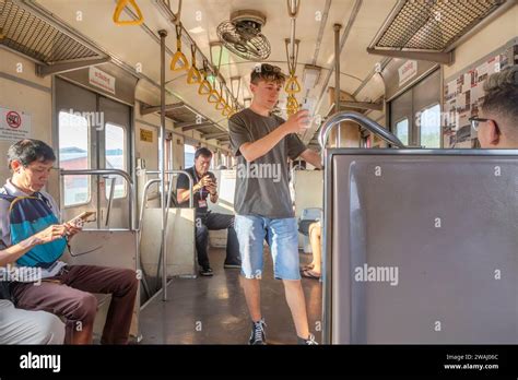 Passengers With Cell Phones On The Railway Train From Ban Na Khwang To
