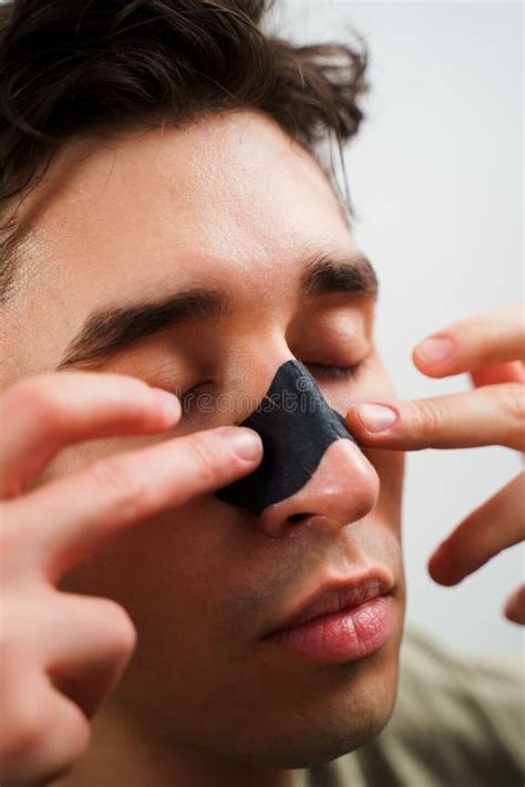Man With Charcoal Nose Strip For Pores Cleaning Young Guy Applying