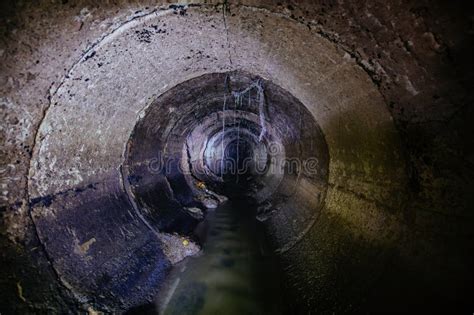 Inside Underground Urban Sewer System Sewage Flowing In Round Sewer