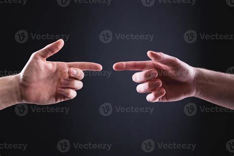 Two Mens Hands Point At Each Other With Index Fingers The Concept Of