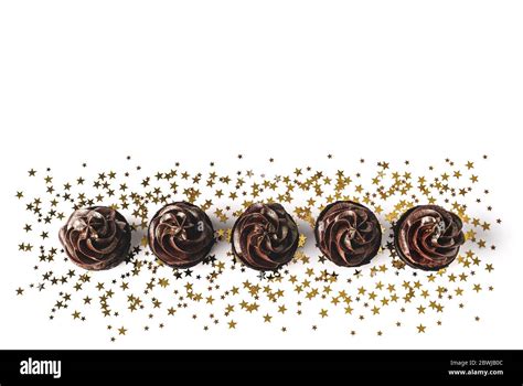 Chocolate Cupcakes With Chocolate Icing And Sprinkled Gold Sparkles On