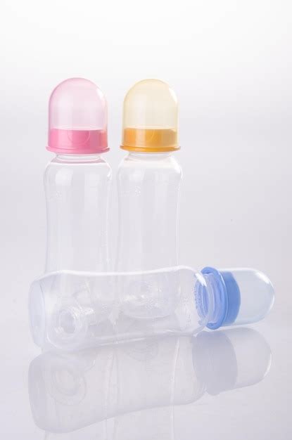 Premium Photo Close Up Of Empty Milk Bottles Against White Background